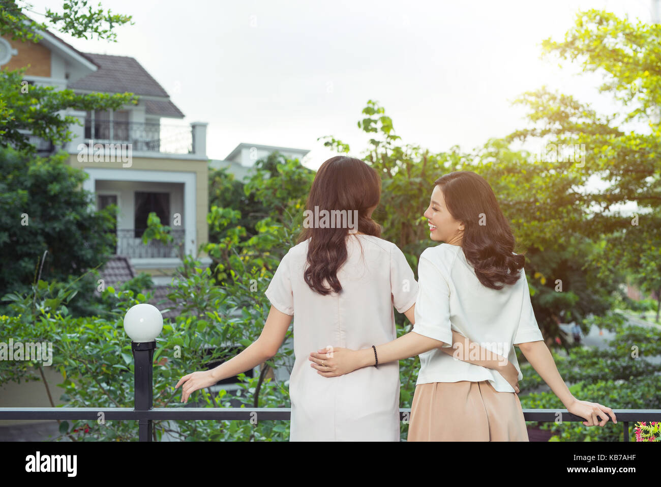 Two happy young women standing hi-res stock photography and images - Alamy