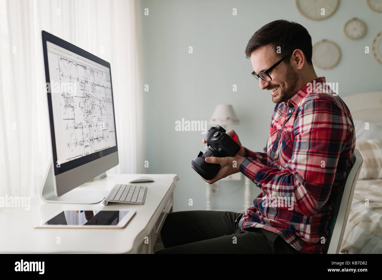 Young handsome designer working on project on computer Stock Photo - Alamy