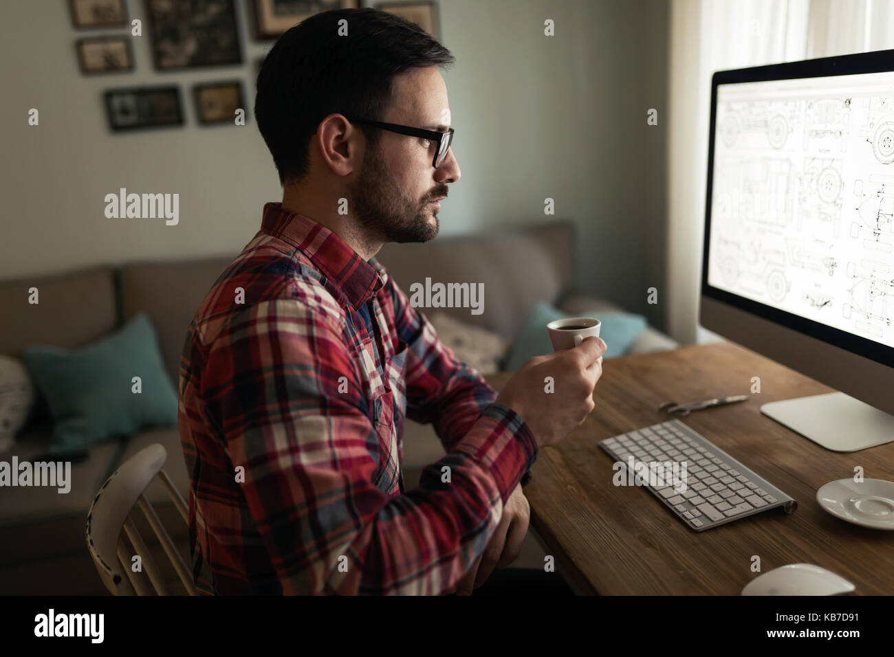 Young handsome designer working on project on computer Stock Photo - Alamy
