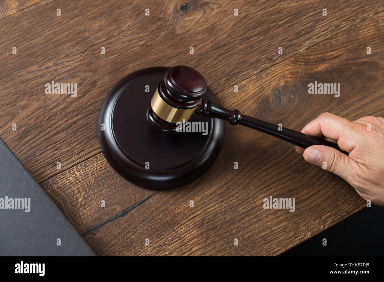 High angle view of male judge striking gavel at table Stock Photo - Alamy