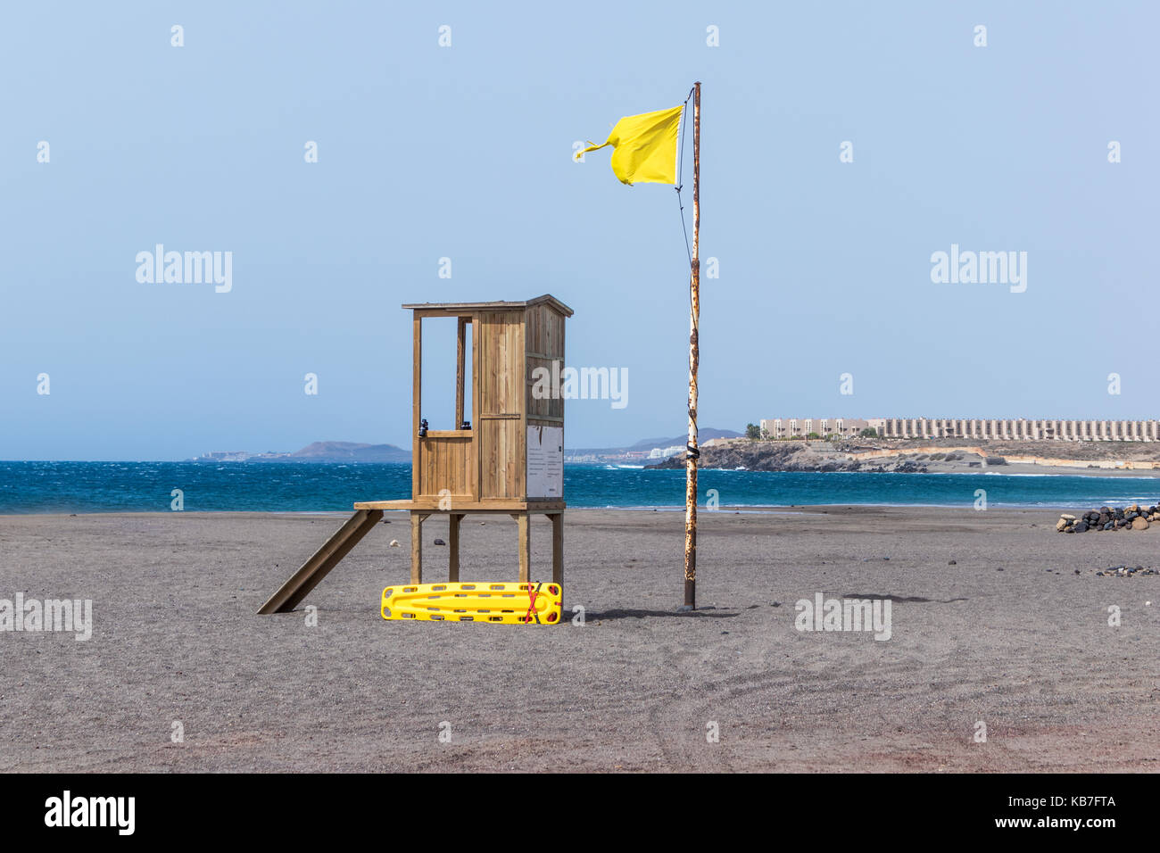 Lonely lifeguard hut with yellow rescue tube on a sandy beach in ...