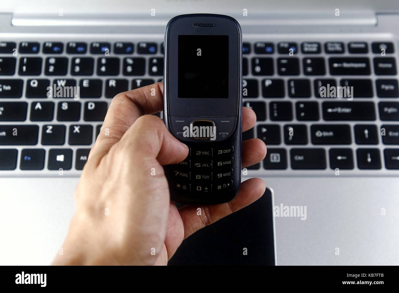 Photo of a cellphone and a laptop computer Stock Photo - Alamy