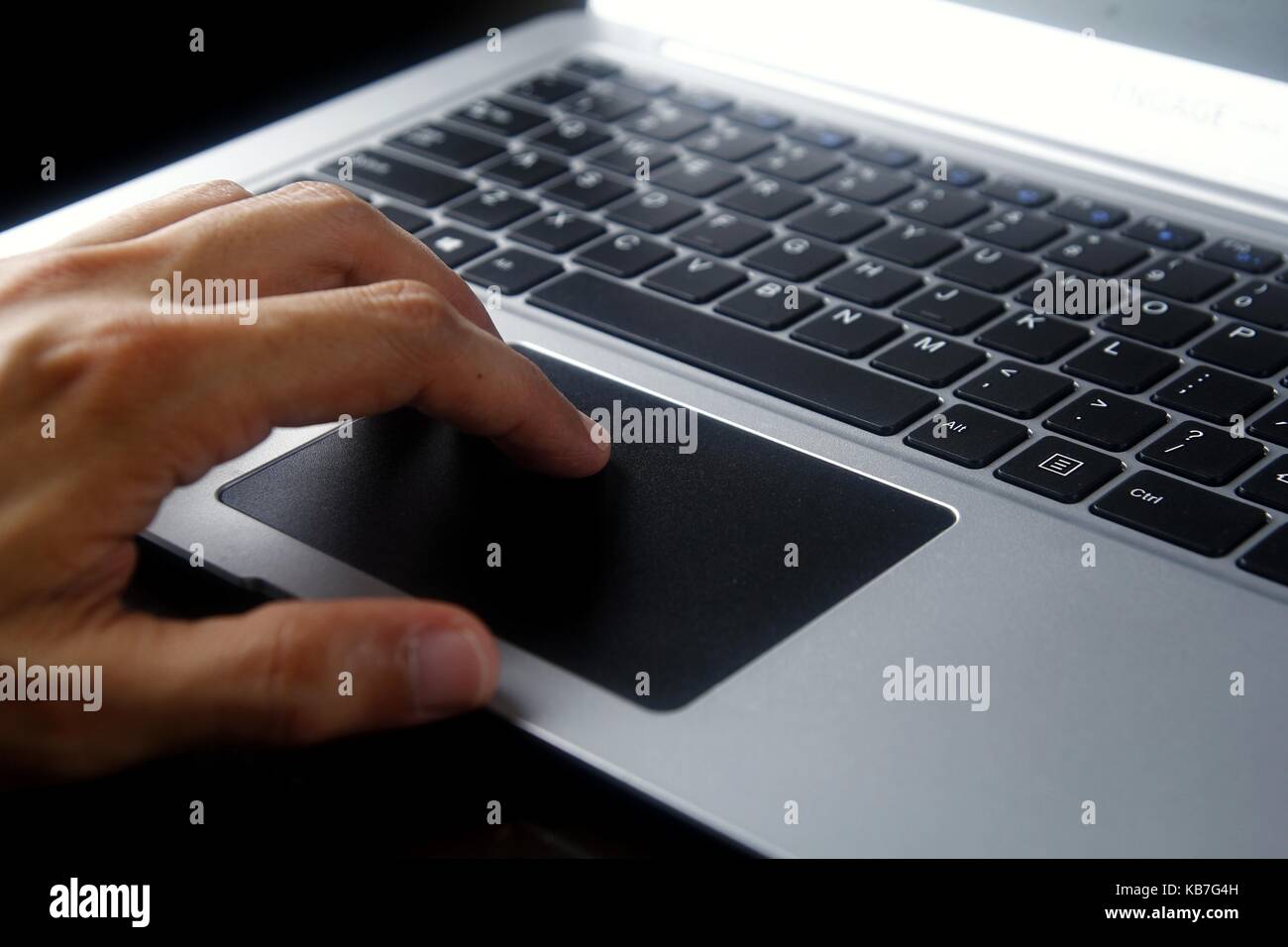 Photo of a hand on a laptop computer keyboard Stock Photo - Alamy