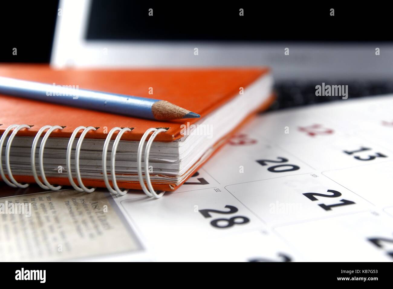 Photo of a calendar, notebook and a laptop computer Stock Photo - Alamy