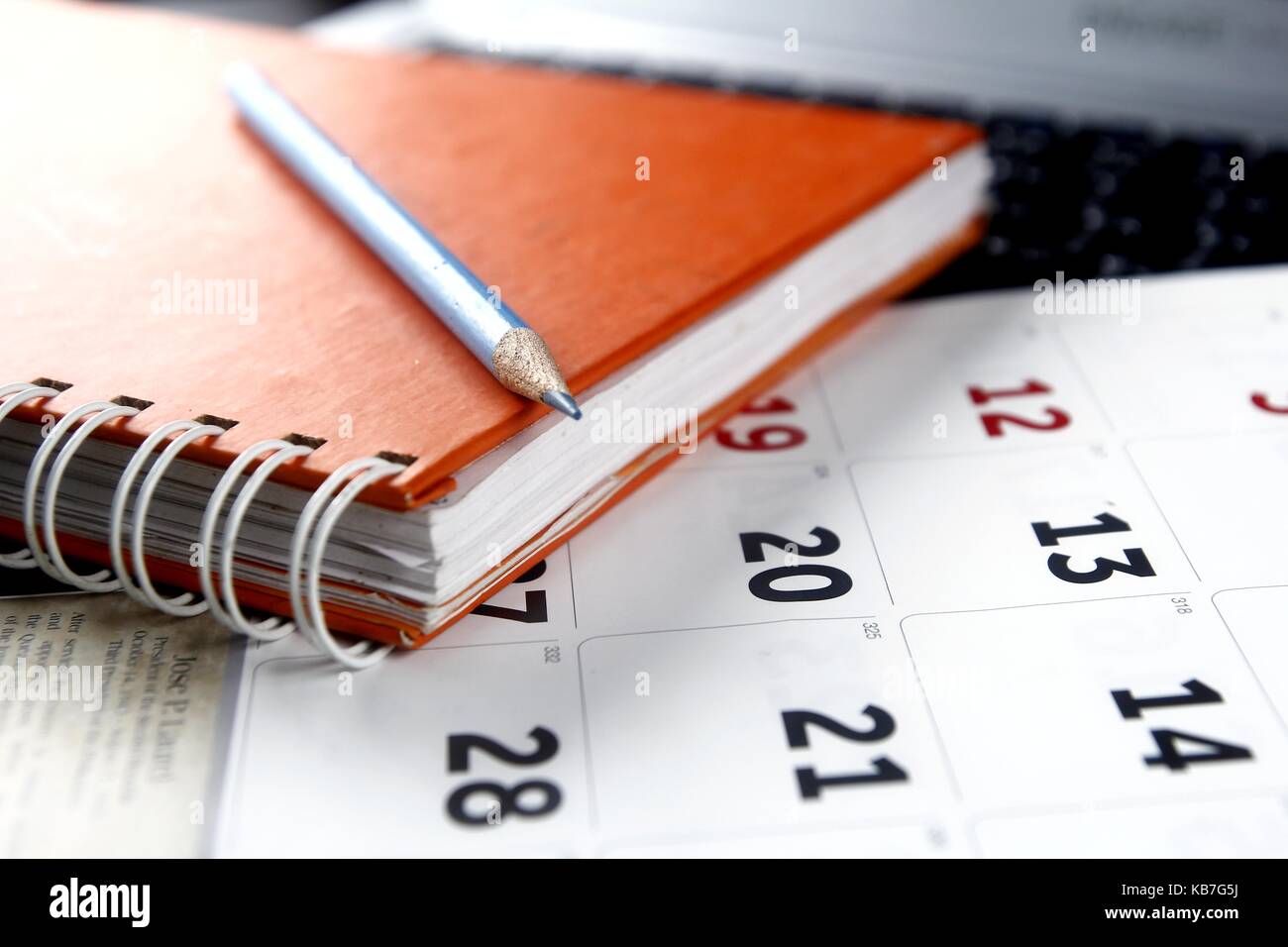 Photo of a calendar, notebook and a laptop computer Stock Photo - Alamy