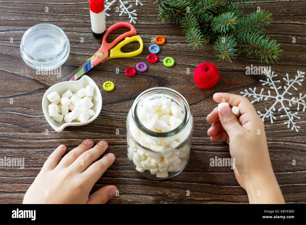 A child is making a Christmas present with a snowman of sweets. Made by ...