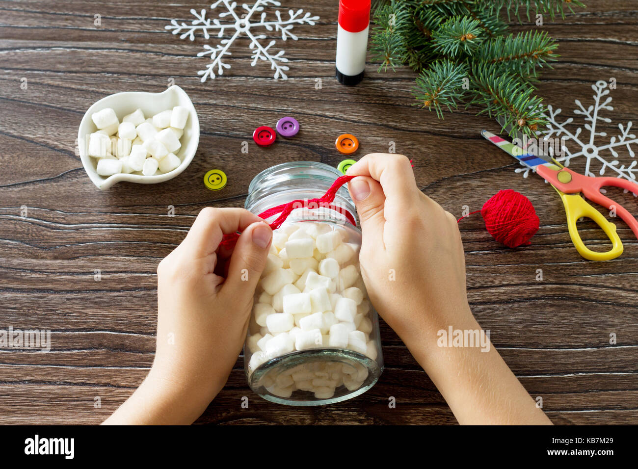A child is making a Christmas present with a snowman of sweets. Made by ...