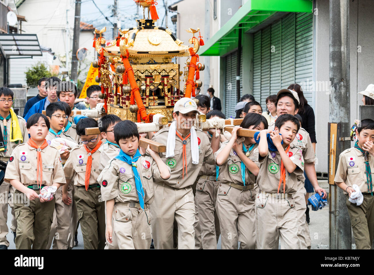 Japan, Osaka, Tada. Yearly Genji parade. Japanese Boy scouts carrying ...