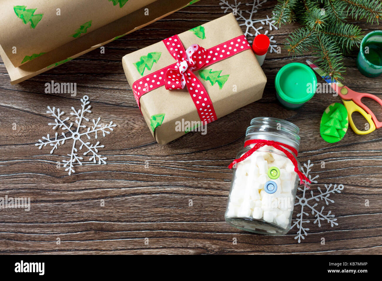 A child is making a Christmas present with a snowman of sweets. Made by ...