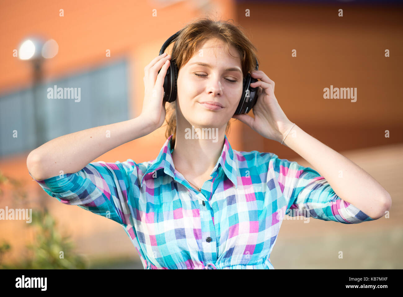 Young beautiful girl listening to music player on the street Stock ...