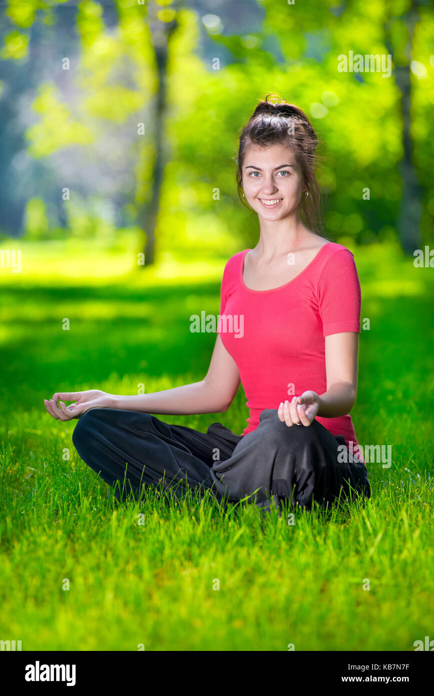 Young woman doing yoga exercises Stock Photo - Alamy