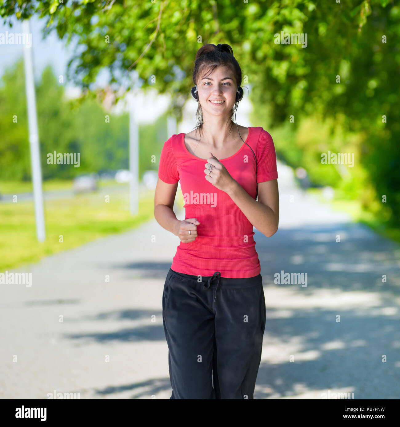 Runner - woman running outdoors in green park Stock Photo - Alamy