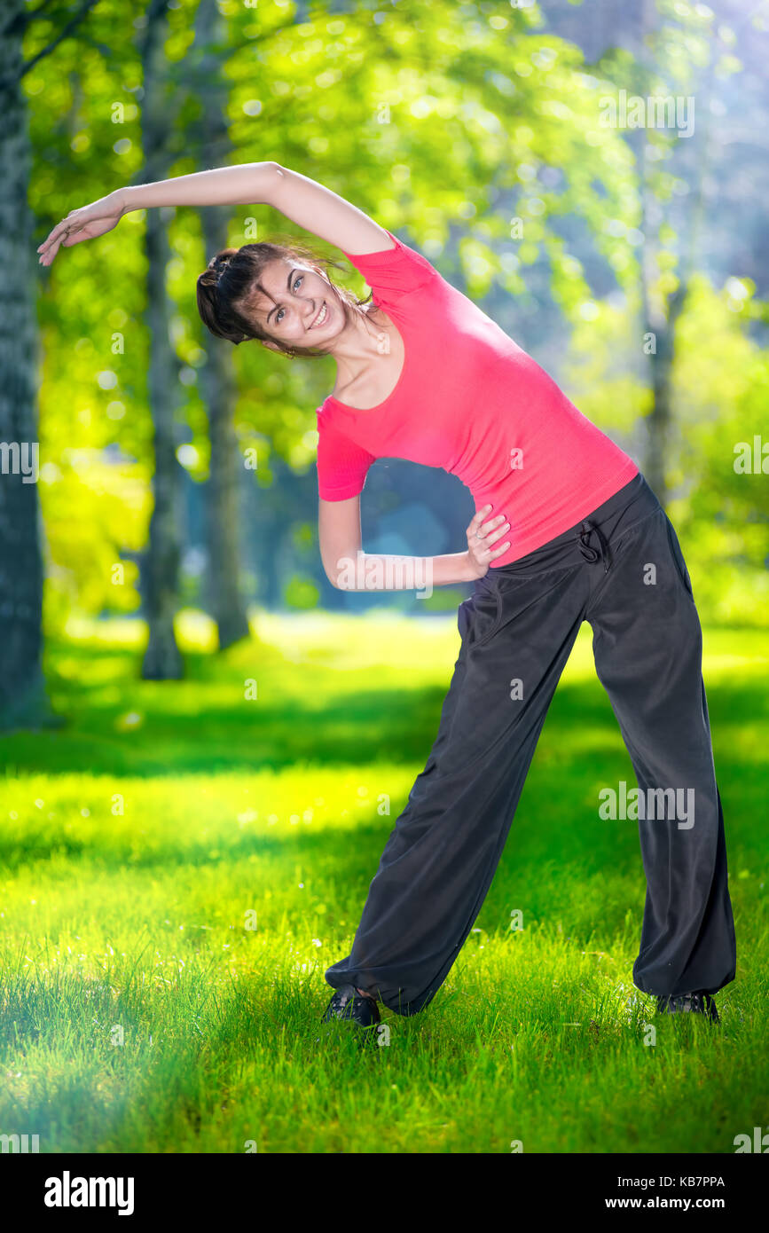Stretching woman in outdoor sport exercise Stock Photo - Alamy