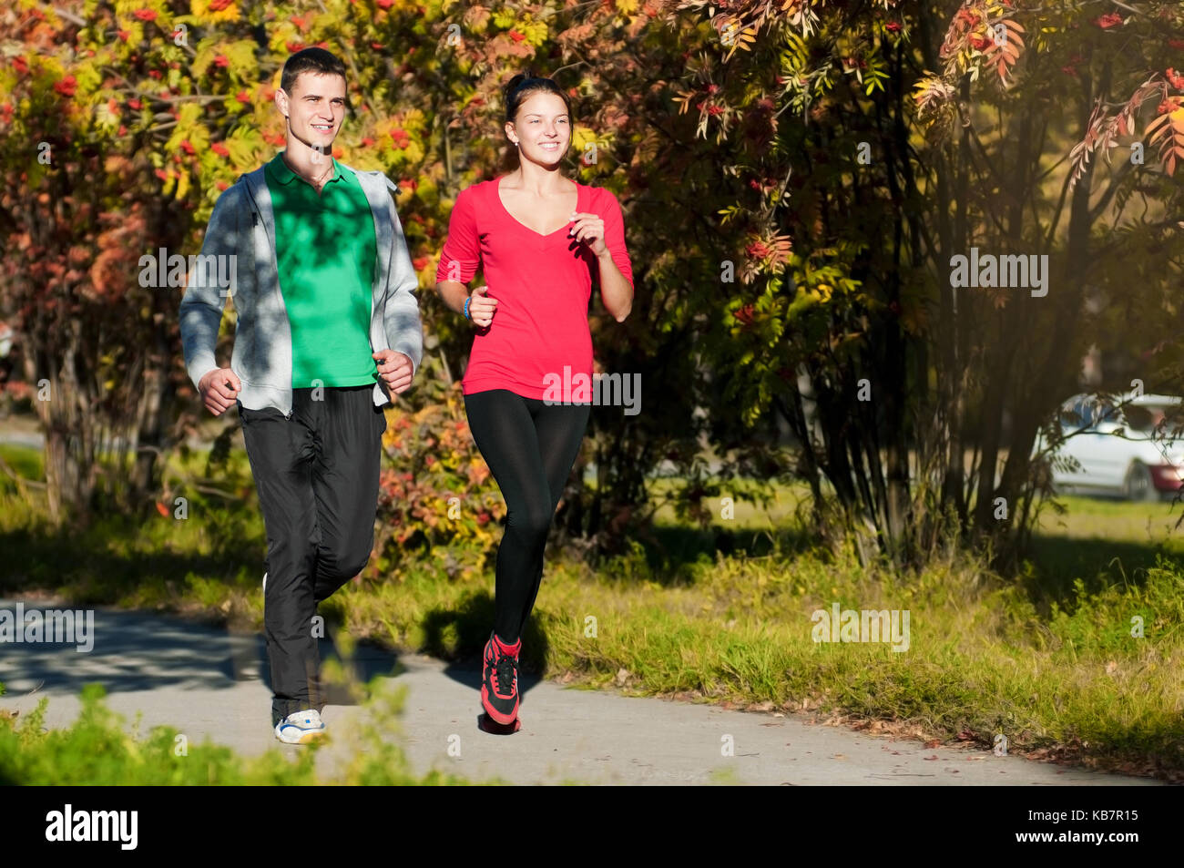Young man and woman running Stock Photo - Alamy