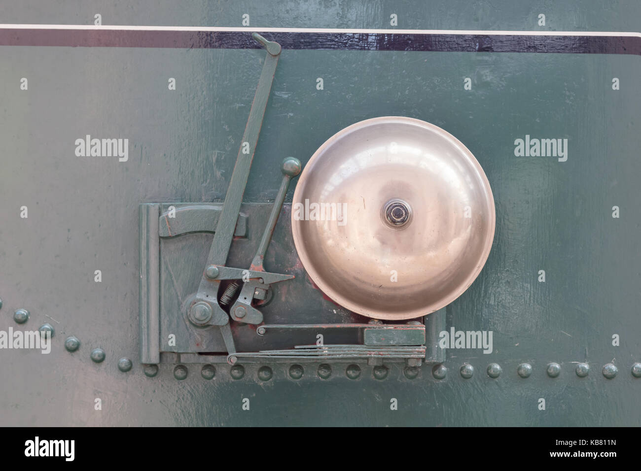 Old bell on a train - For giving warning signals Stock Photo - Alamy
