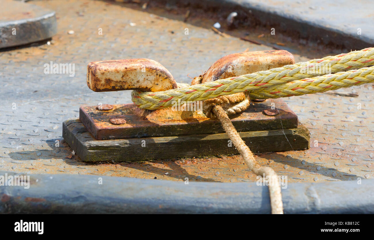 Metal bollard, many ropes on a dock Stock Photo - Alamy