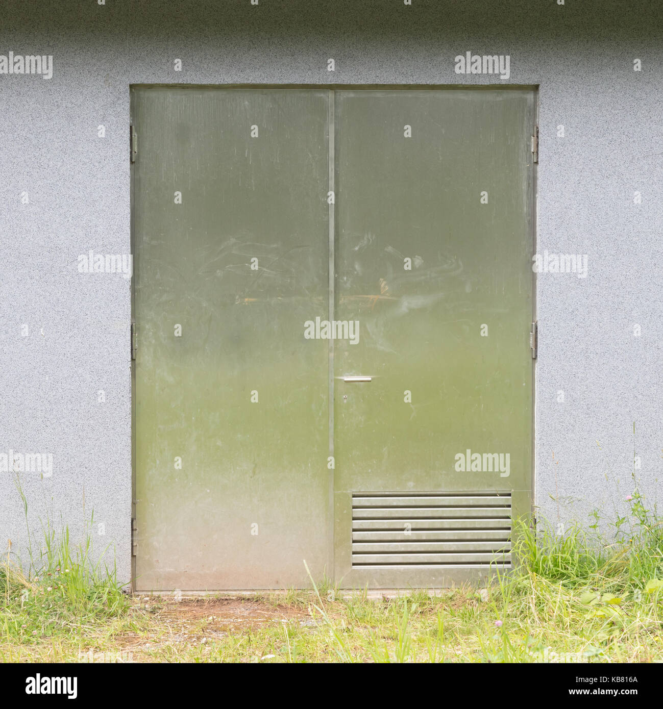 Concrete storage box in the Alps - Big metal doors Stock Photo - Alamy