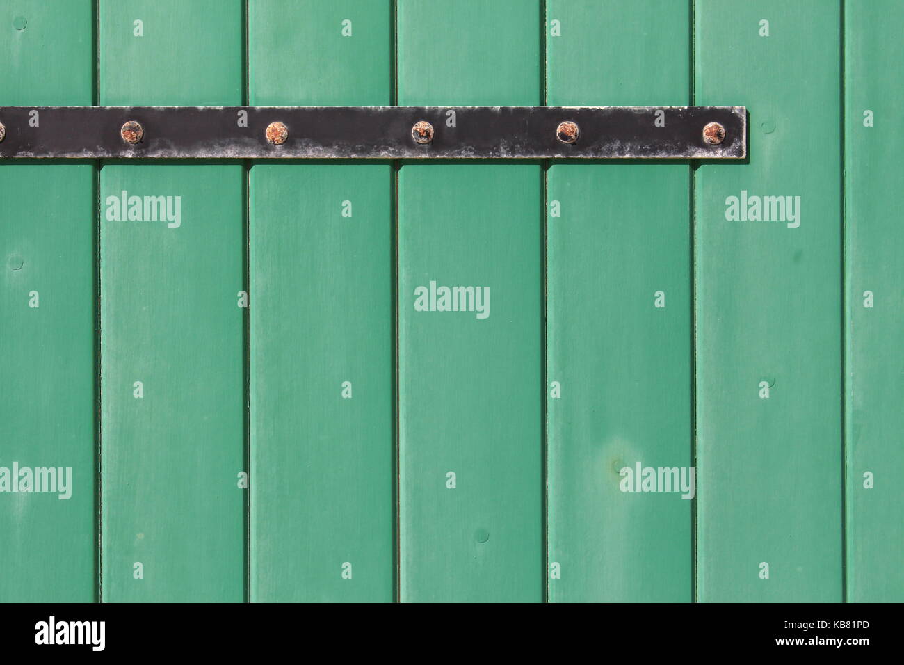 Background texture of a green painted wooden door, with black metal ...
