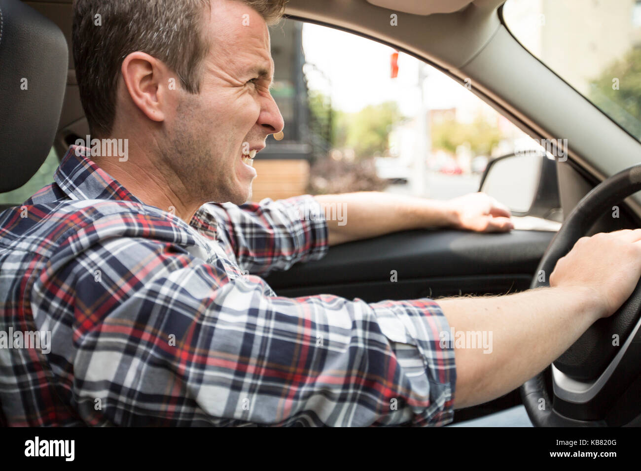 Irritated young man driving a car. Irritated driver Stock Photo - Alamy