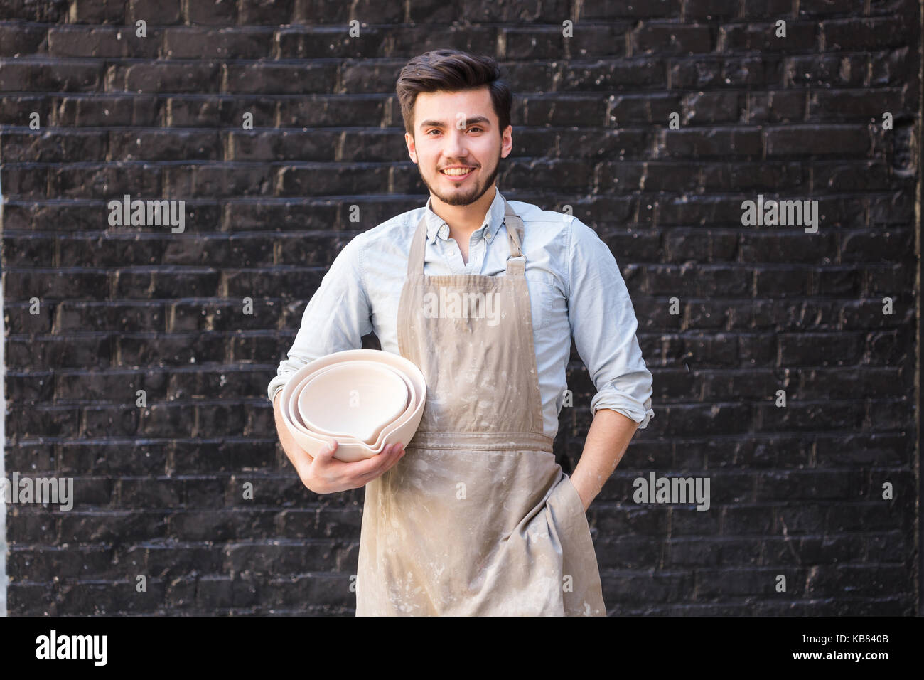 pottery, utensils, ceramics art concept - smiling male ceramist with ...