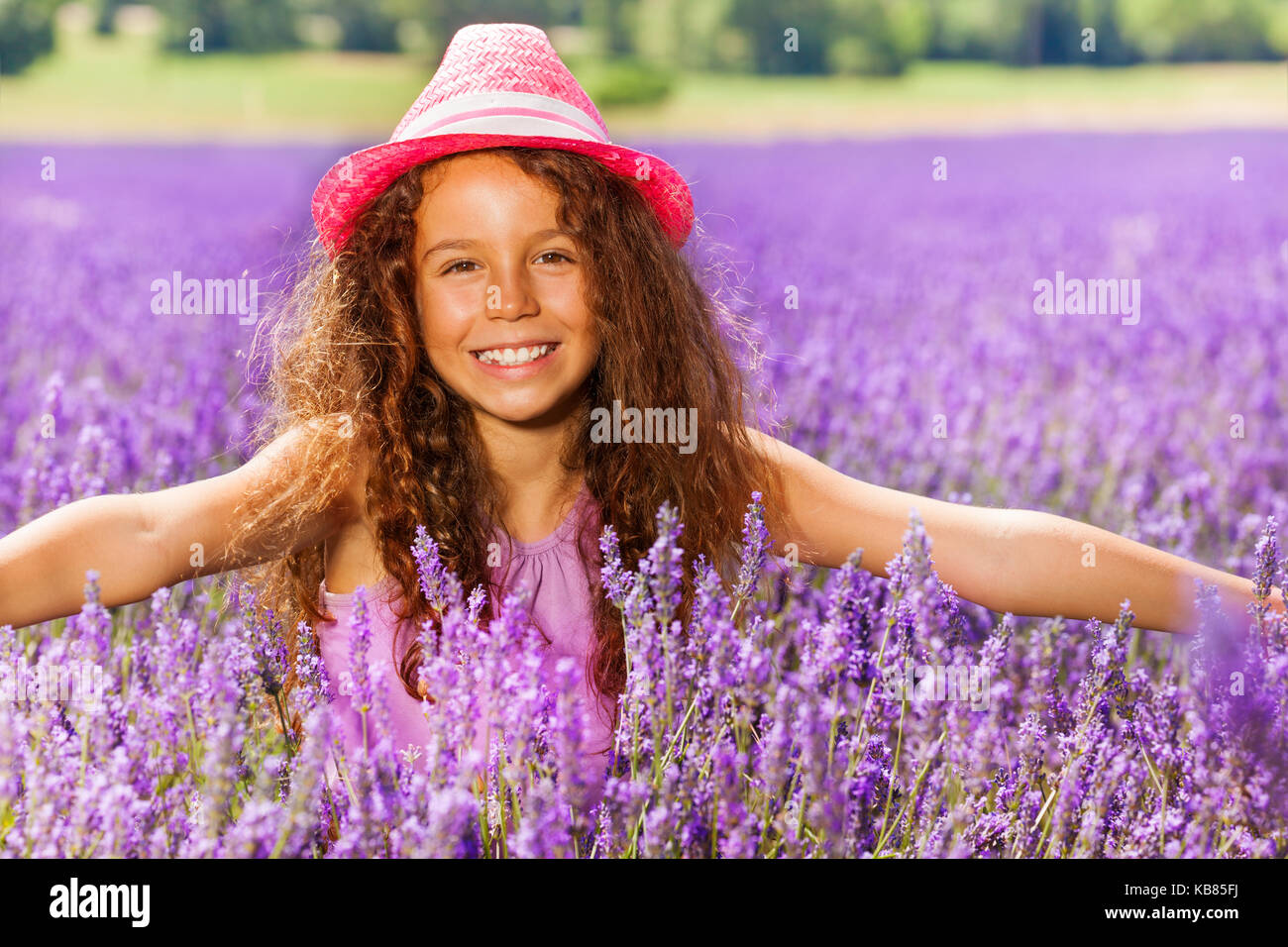 Happy girl hiding in lavender field Stock Photo - Alamy