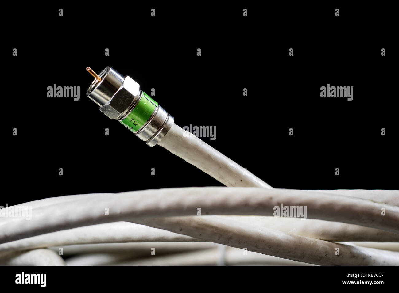 Old entangled cables, electronics and old cable connectors on a black ...