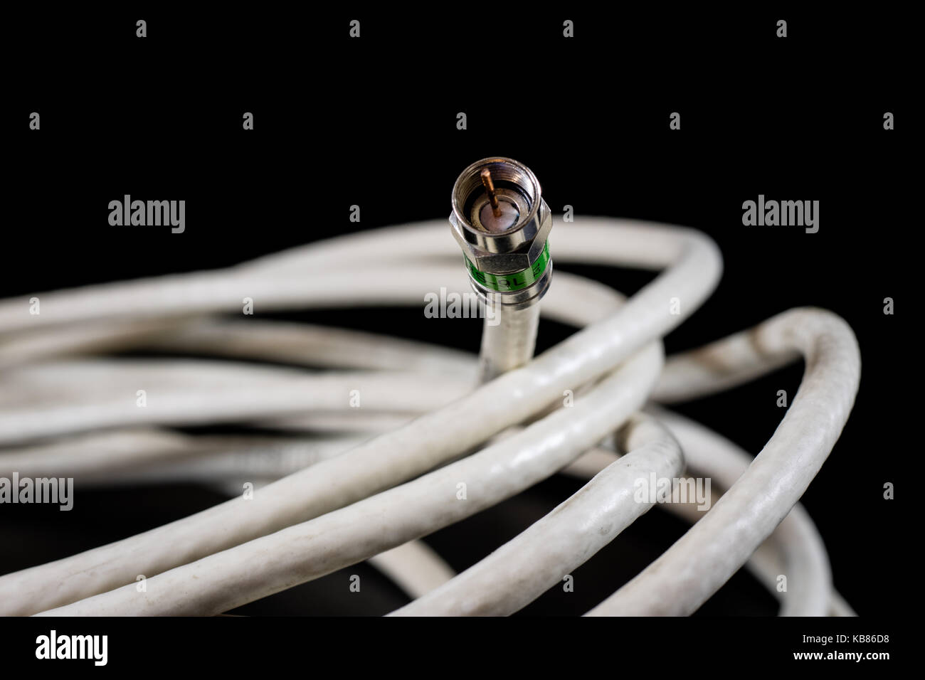 Old entangled cables, electronics and old cable connectors on a black ...