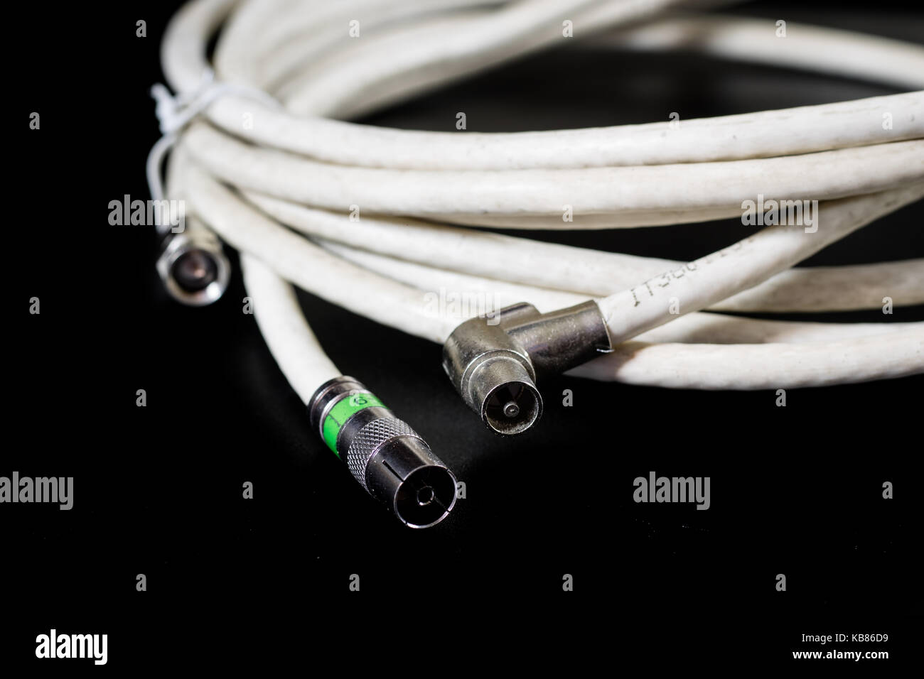 Old entangled cables, electronics and old cable connectors on a black ...