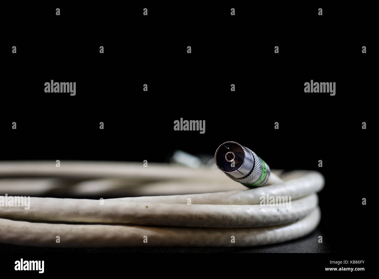 Old entangled cables, electronics and old cable connectors on a black ...