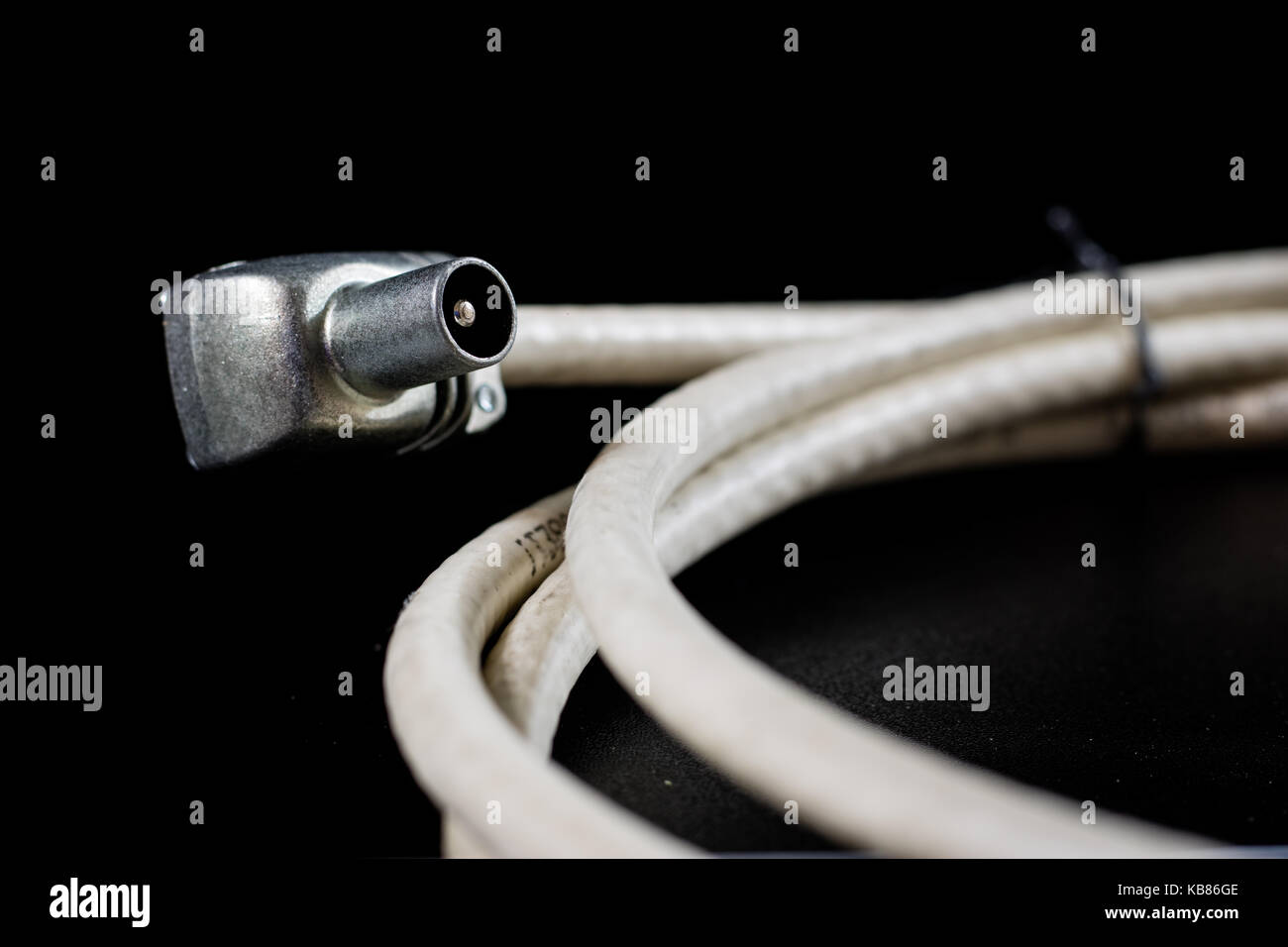 Old entangled cables, electronics and old cable connectors on a black ...