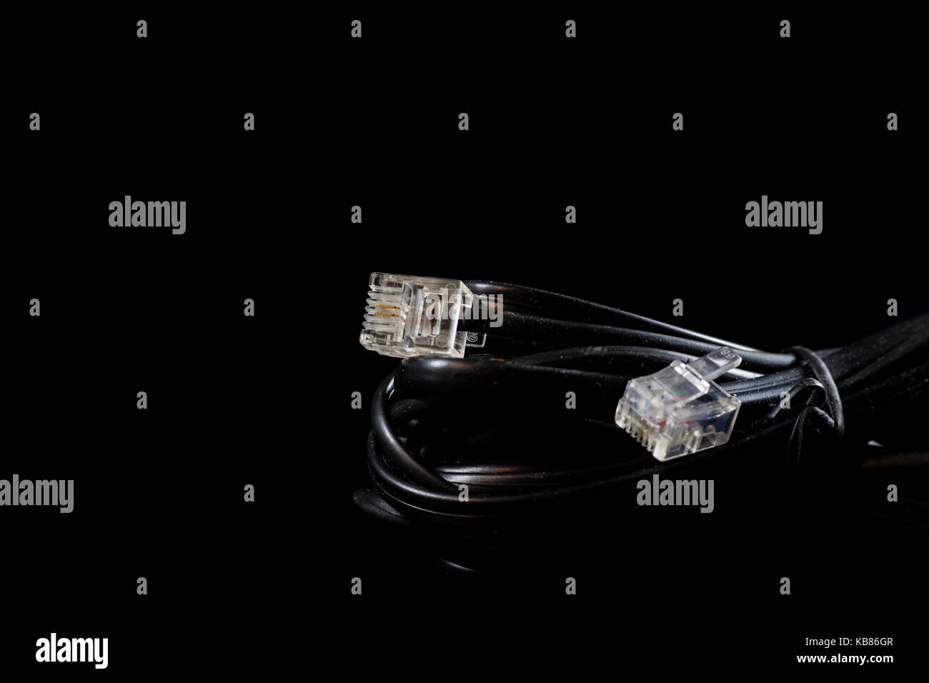 Old entangled cables, electronics and old cable connectors on a black ...