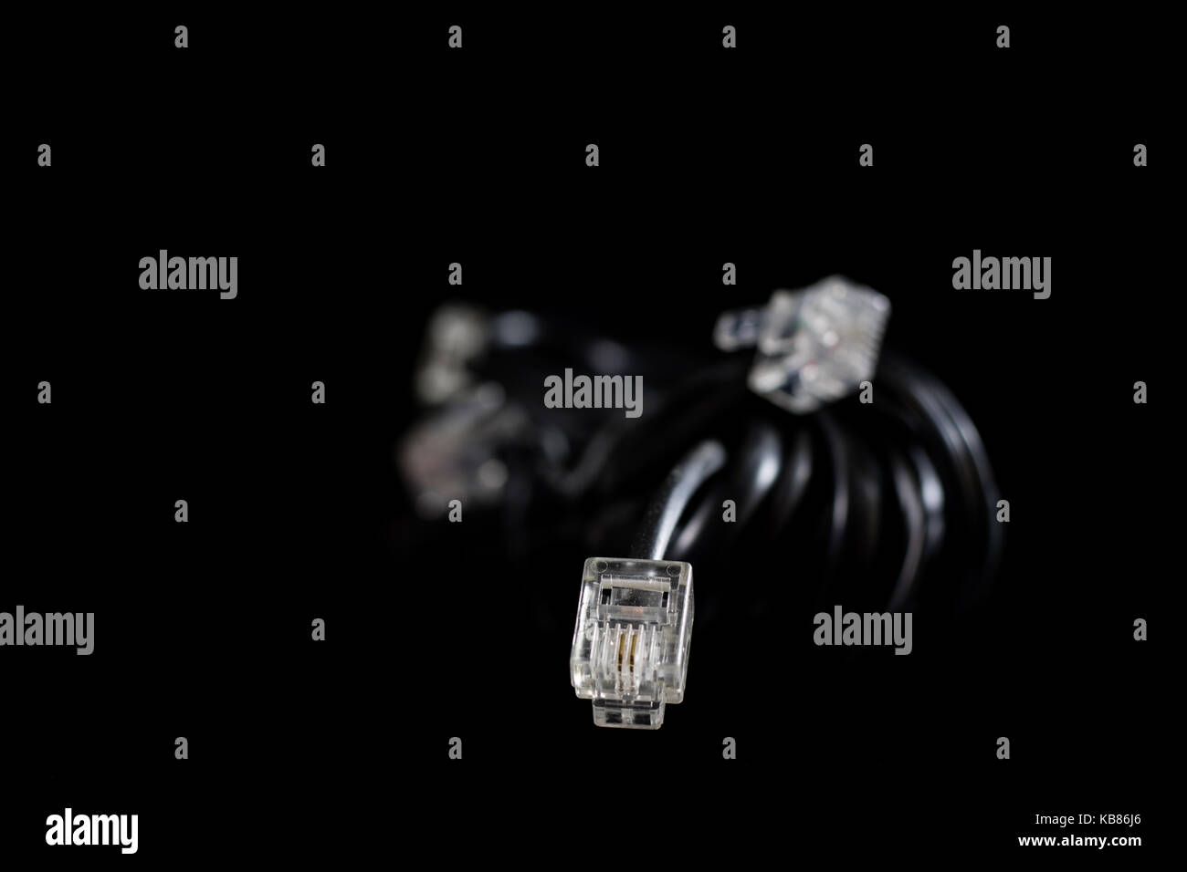 Old entangled cables, electronics and old cable connectors on a black ...