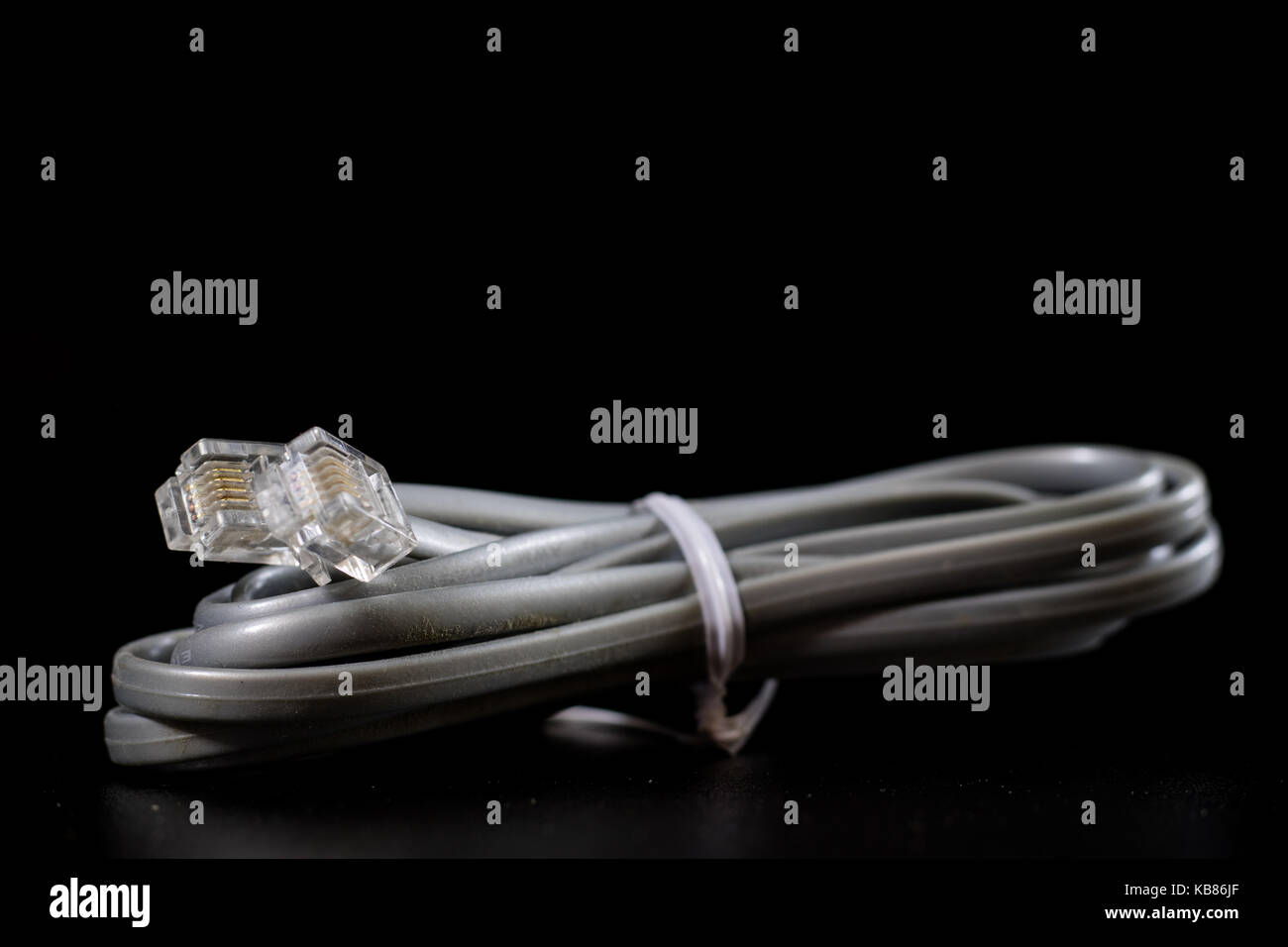 Old entangled cables, electronics and old cable connectors on a black ...