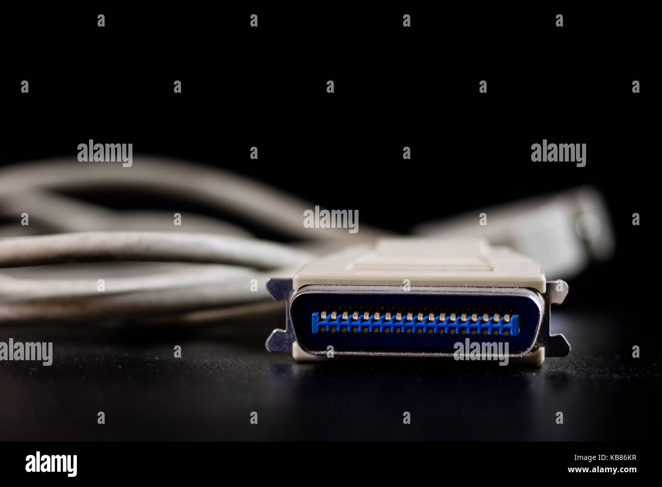 Old entangled cables, electronics and old cable connectors on a black ...