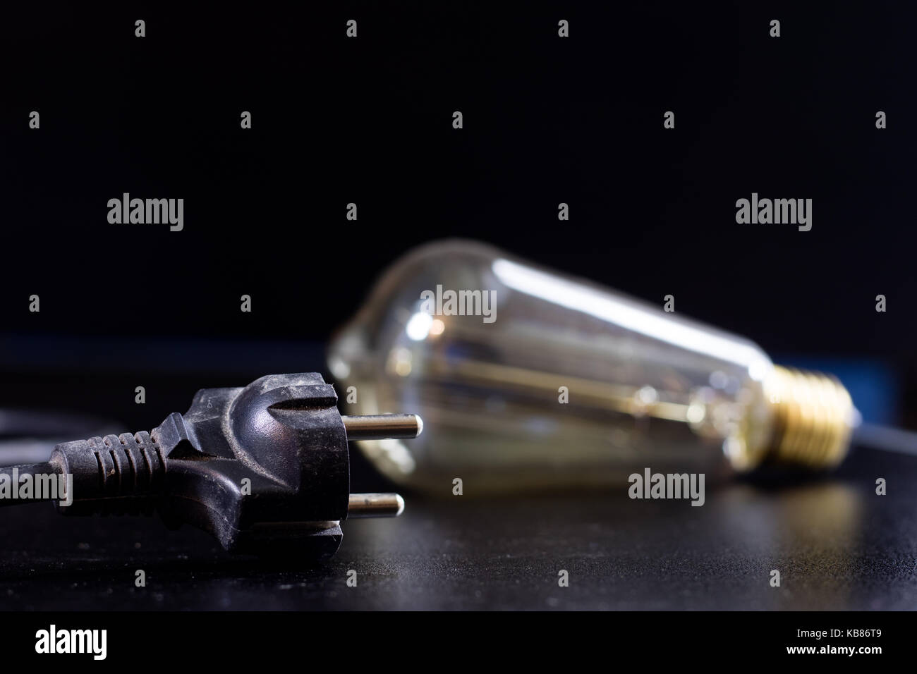 Old entangled cables, electronics and old cable connectors on a black ...