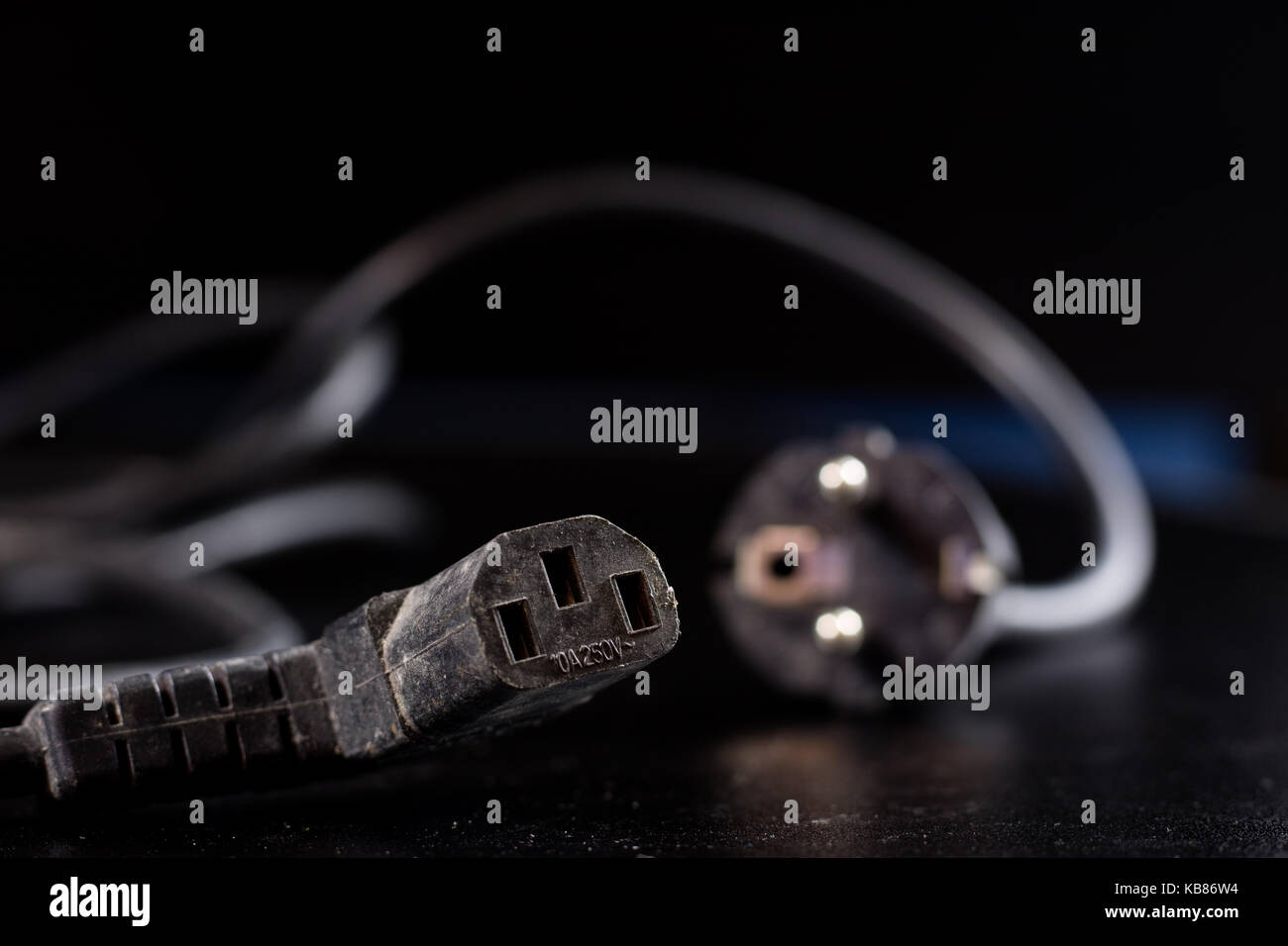 Old entangled cables, electronics and old cable connectors on a black ...