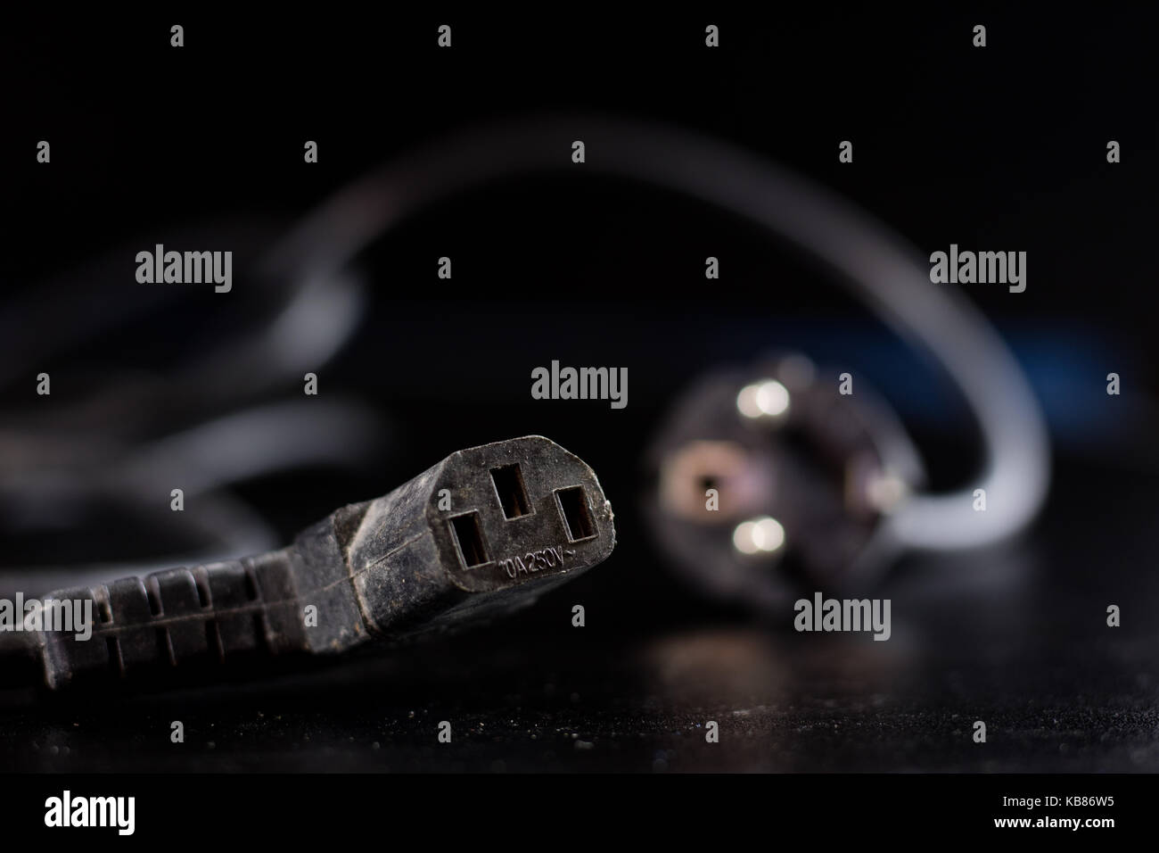 Old entangled cables, electronics and old cable connectors on a black ...