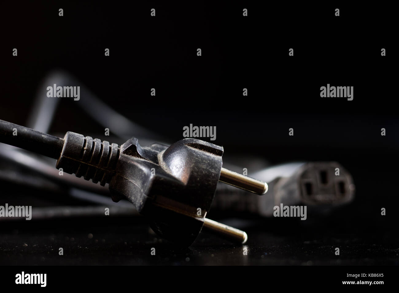 Old entangled cables, electronics and old cable connectors on a black ...