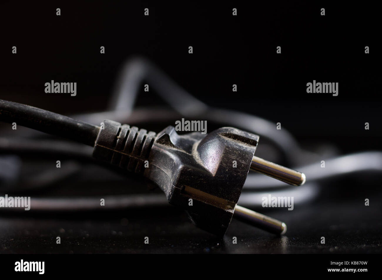 Old entangled cables, electronics and old cable connectors on a black ...