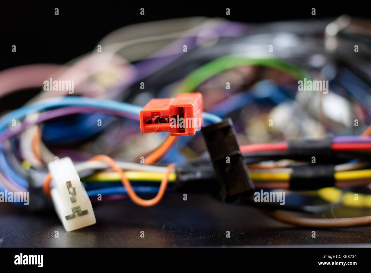 Old entangled cables, electronics and old cable connectors on a black ...