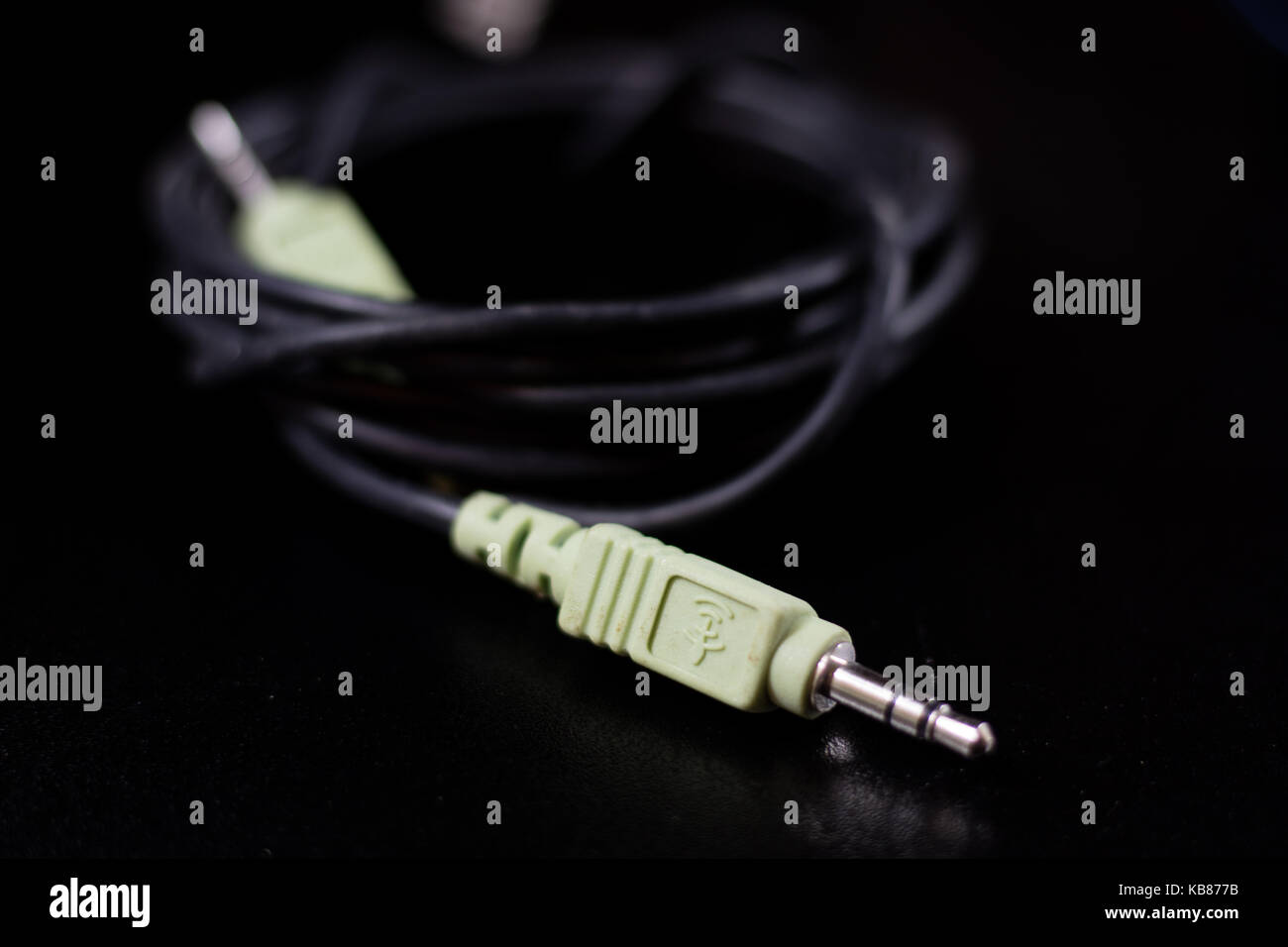 Old entangled cables, electronics and old cable connectors on a black ...