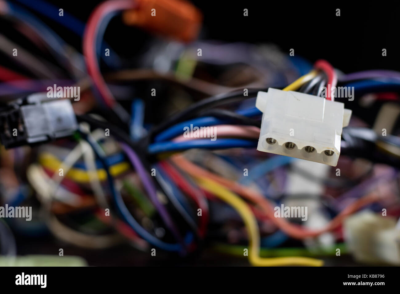 Old entangled cables, electronics and old cable connectors on a black ...