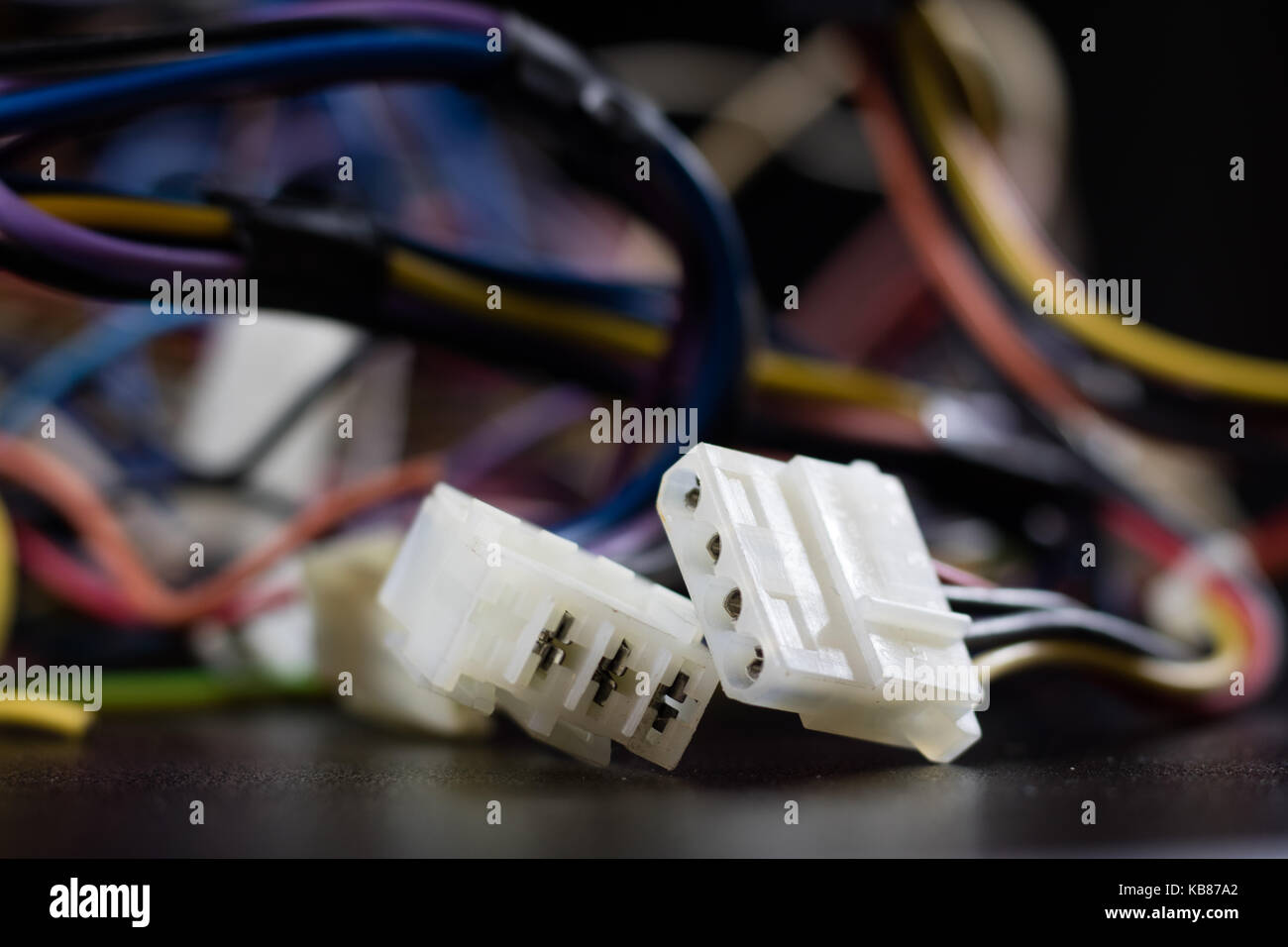 Old entangled cables, electronics and old cable connectors on a black ...