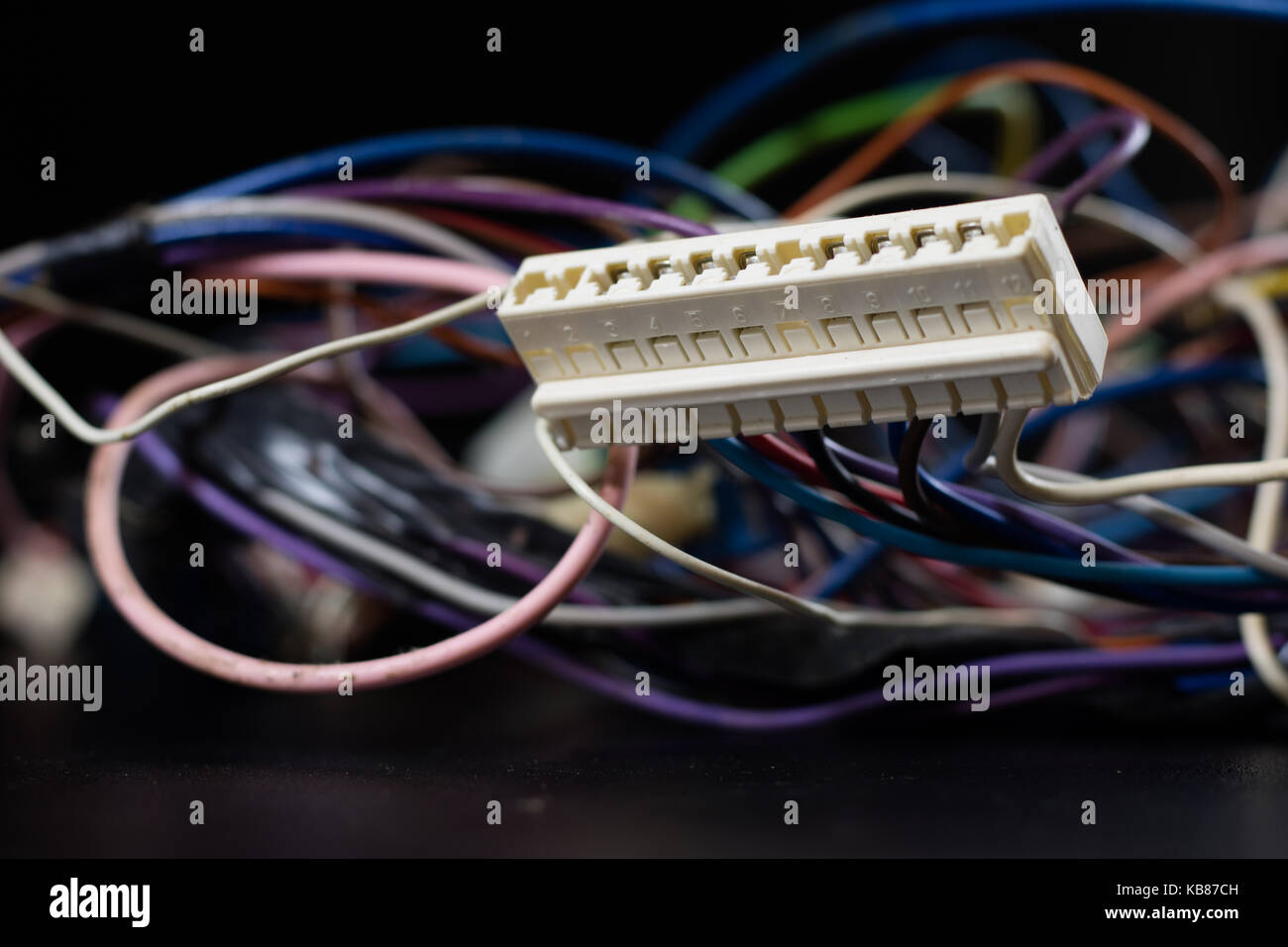 Old entangled cables, electronics and old cable connectors on a black ...