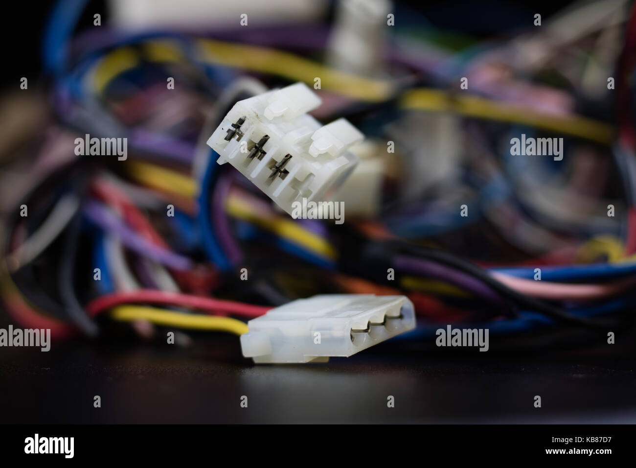 Old entangled cables, electronics and old cable connectors on a black ...