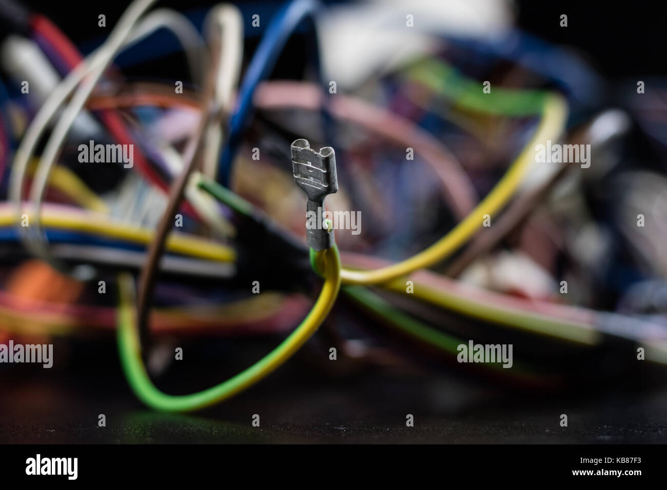 Old entangled cables, electronics and old cable connectors on a black ...