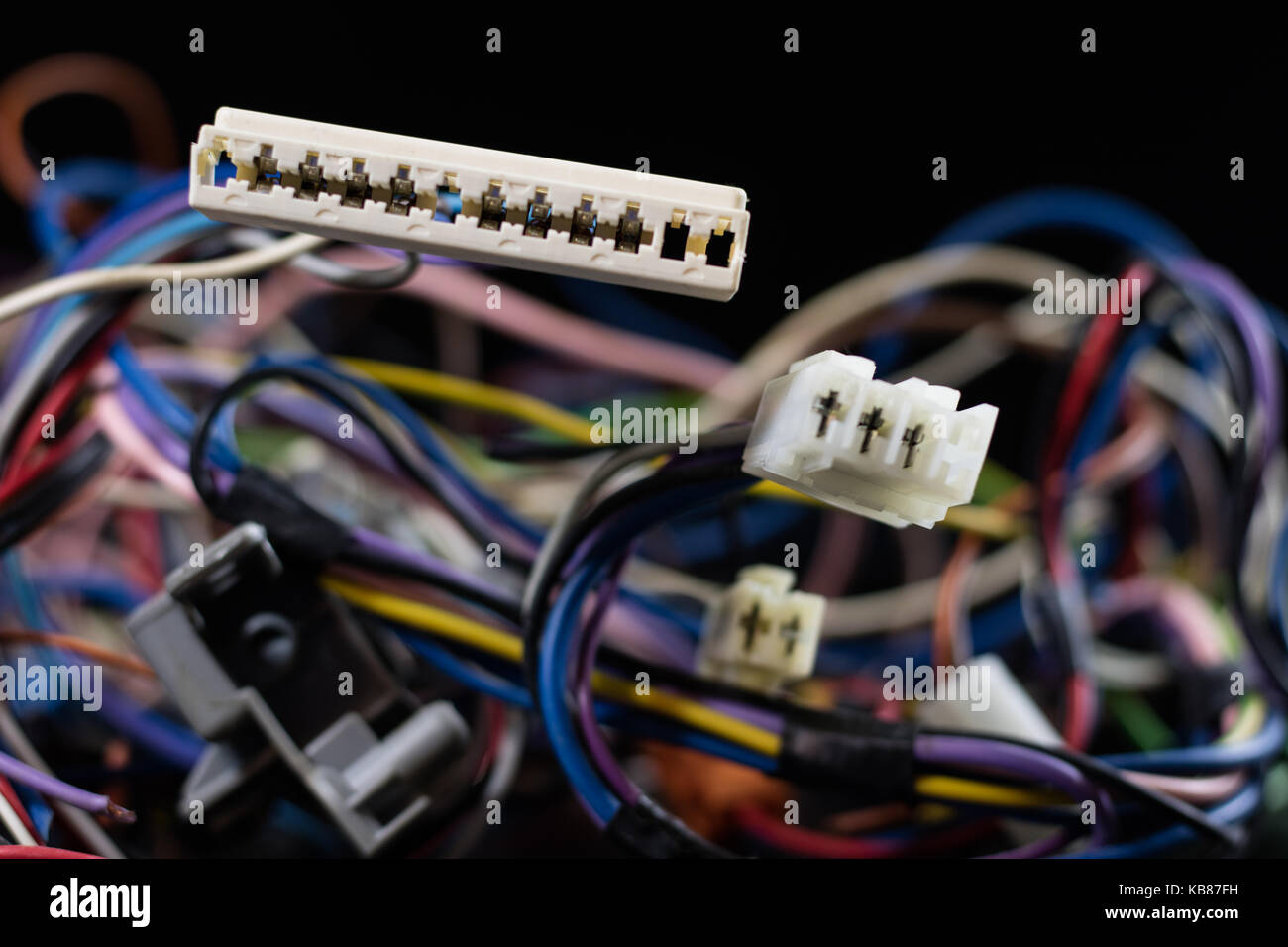 Old entangled cables, electronics and old cable connectors on a black ...