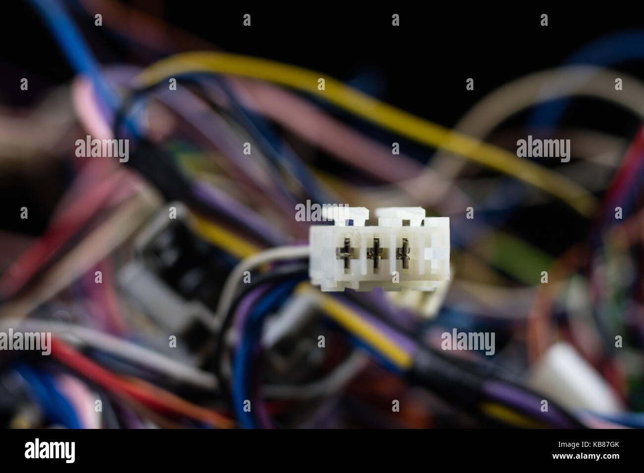 Old entangled cables, electronics and old cable connectors on a black ...