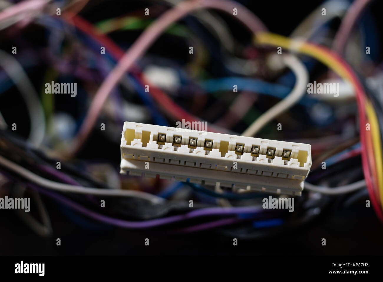 Old entangled cables, electronics and old cable connectors on a black ...