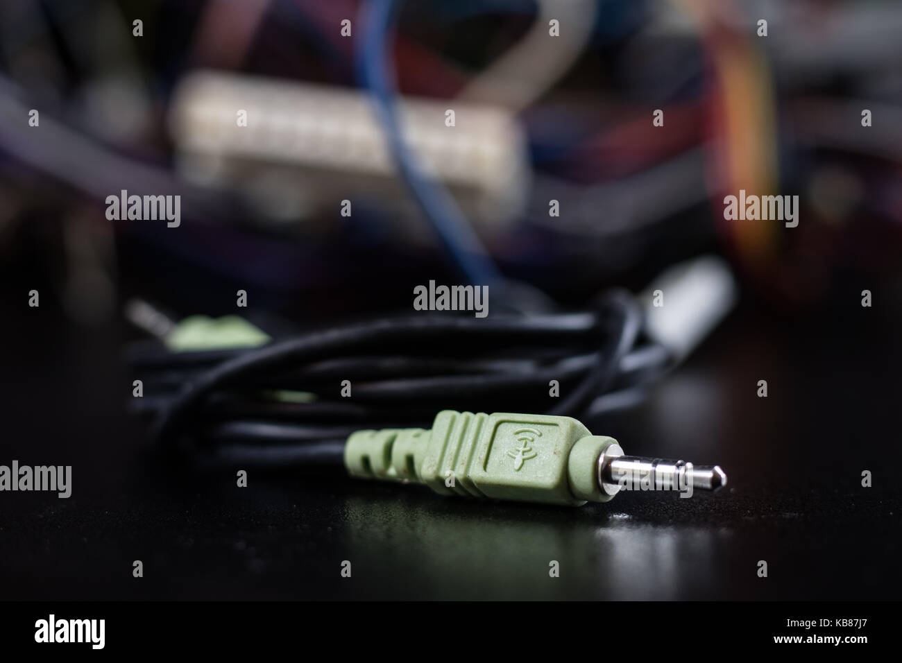 Old entangled cables, electronics and old cable connectors on a black ...